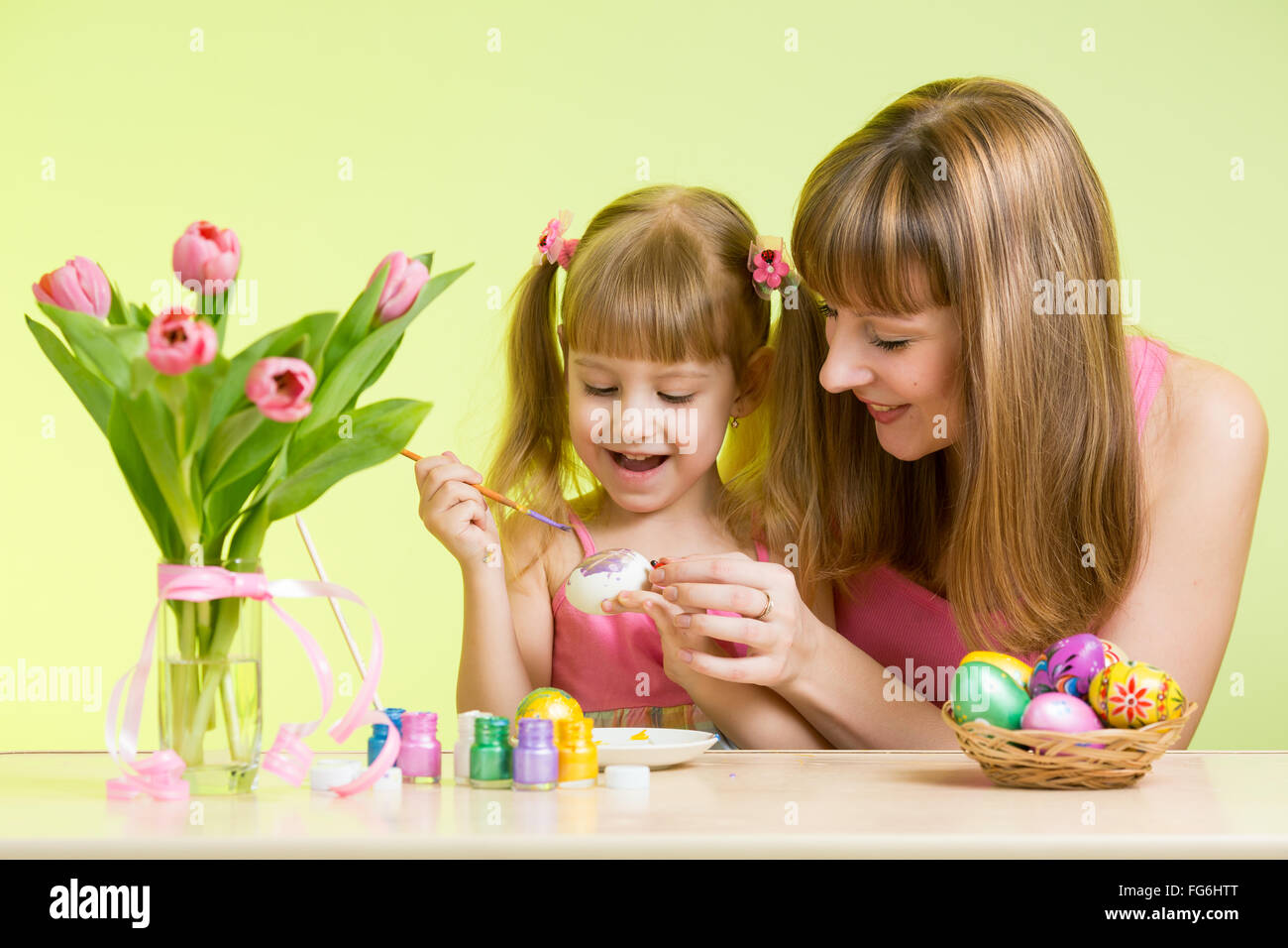 happy mother and child daughter prepare to Easter holiday with brush ...