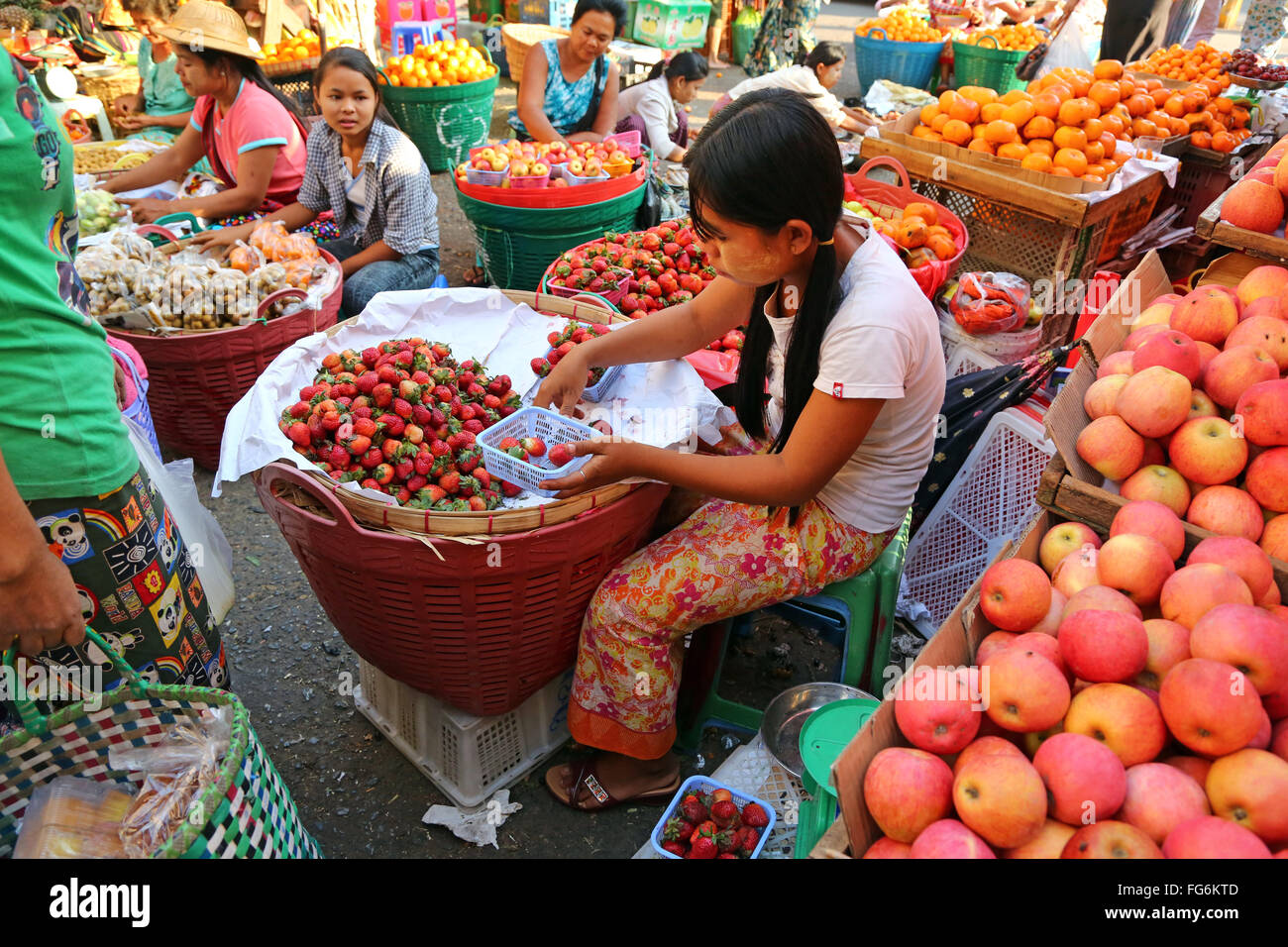 Girl selling strawberries in a street market, Yangon, Myanmar Stock ...