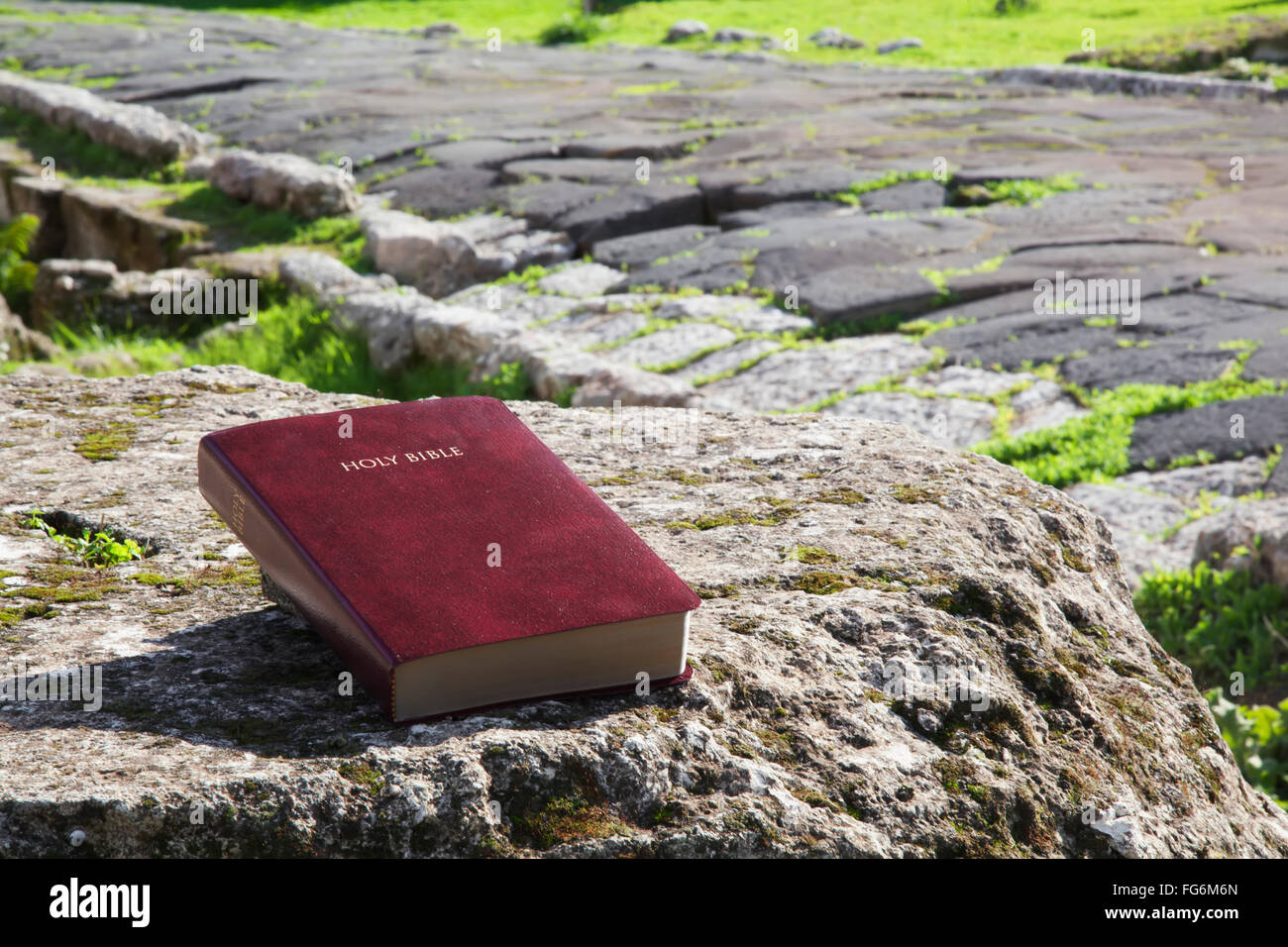 Bible sitting on an old rock at an ancient ruins site; Tarsus, Turkey ...