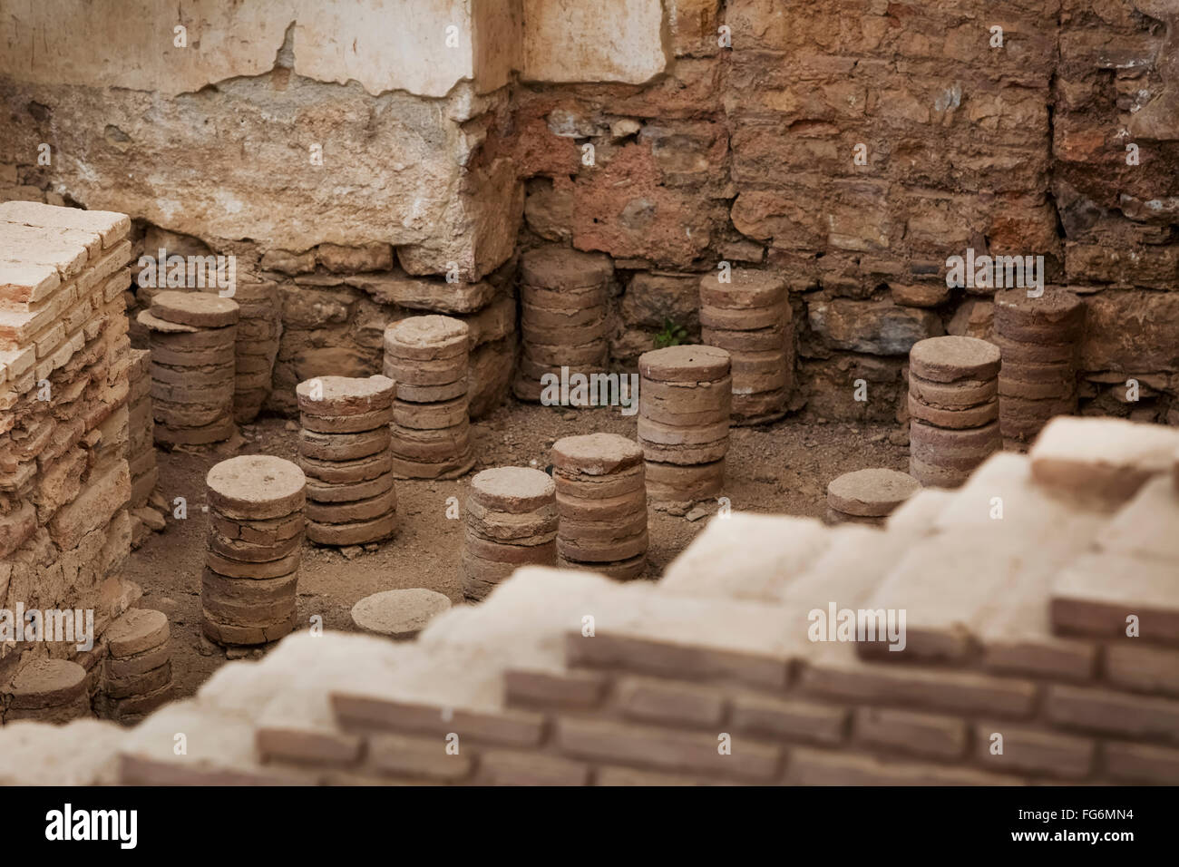 Ancient stone walls and seating in a steam room in a museum; Ephesus ...