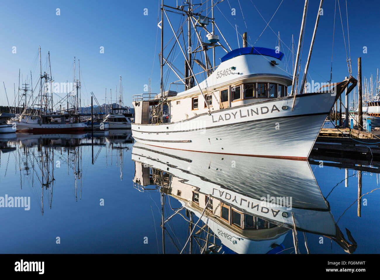 The Fishing Boat LadyLinda moored in the Sitka Harbor is reflected in ...