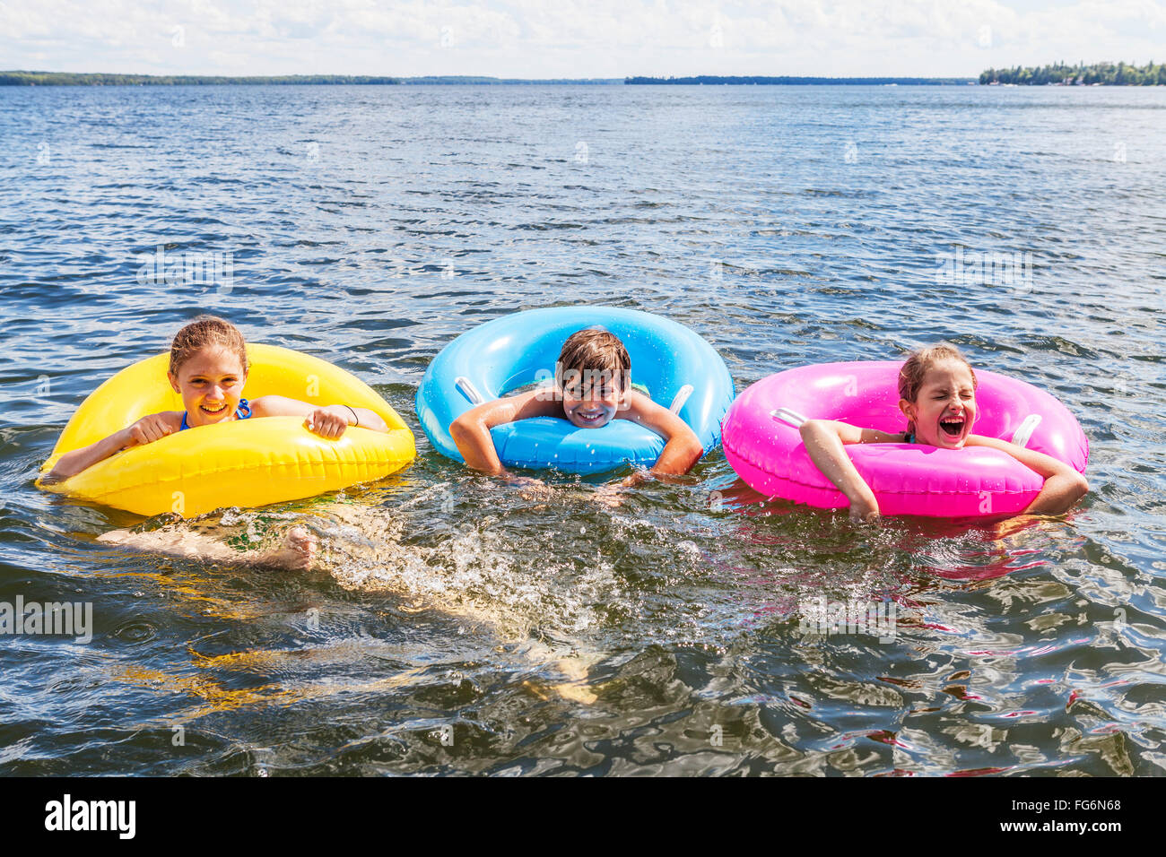 Kids playing with inflatable rings hi-res stock photography and images ...