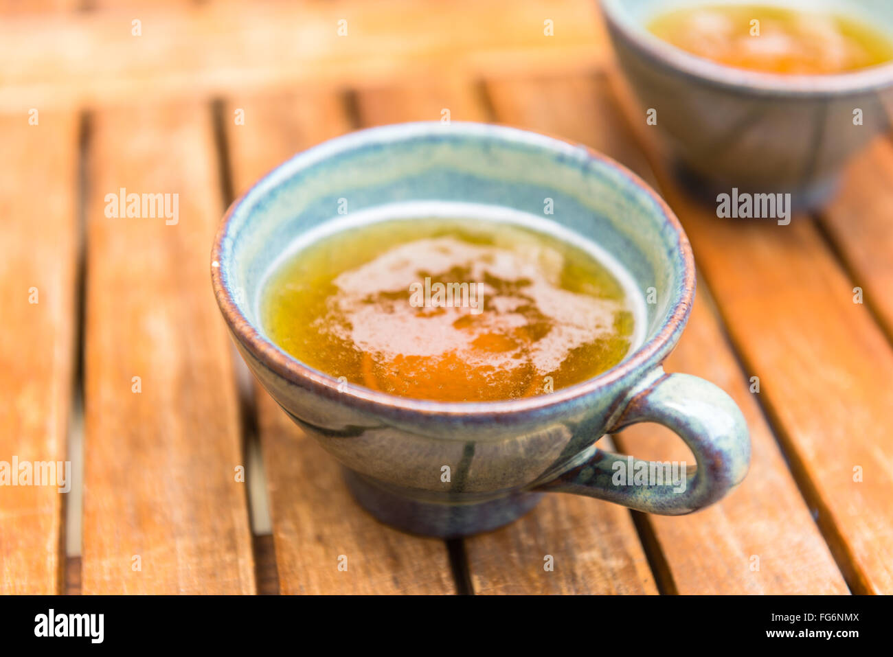 Norman apple cider in a typical ceramic cups. Shot with a selective ...