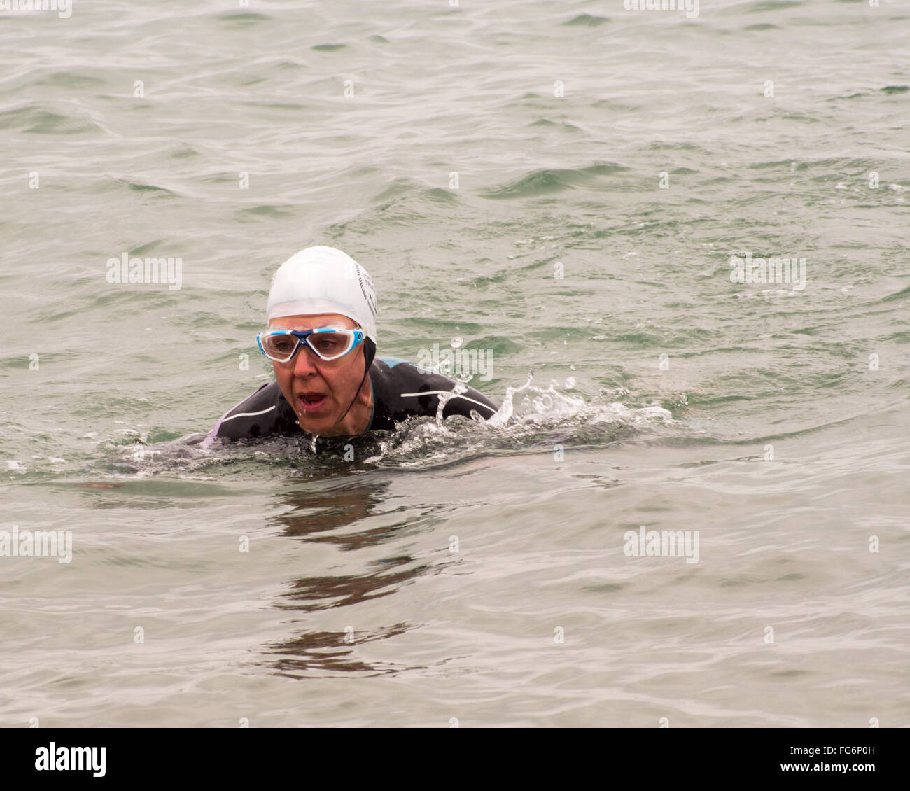 A female tri-athlete swimming in the sea Stock Photo - Alamy