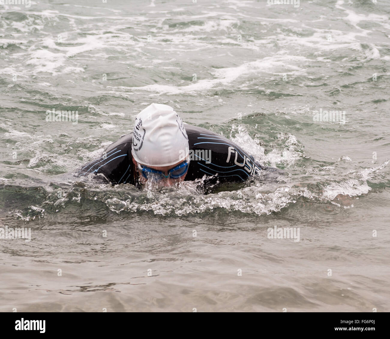 A female tri-athlete swimming in the sea Stock Photo - Alamy