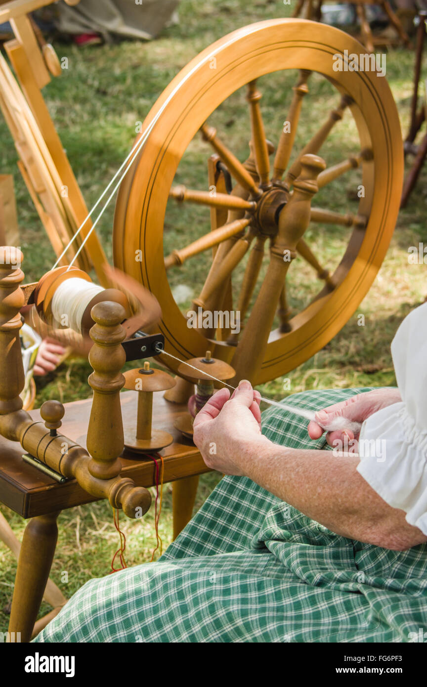 Woman spinning wool into yarn using a spinning wheel at the Clackamas ...