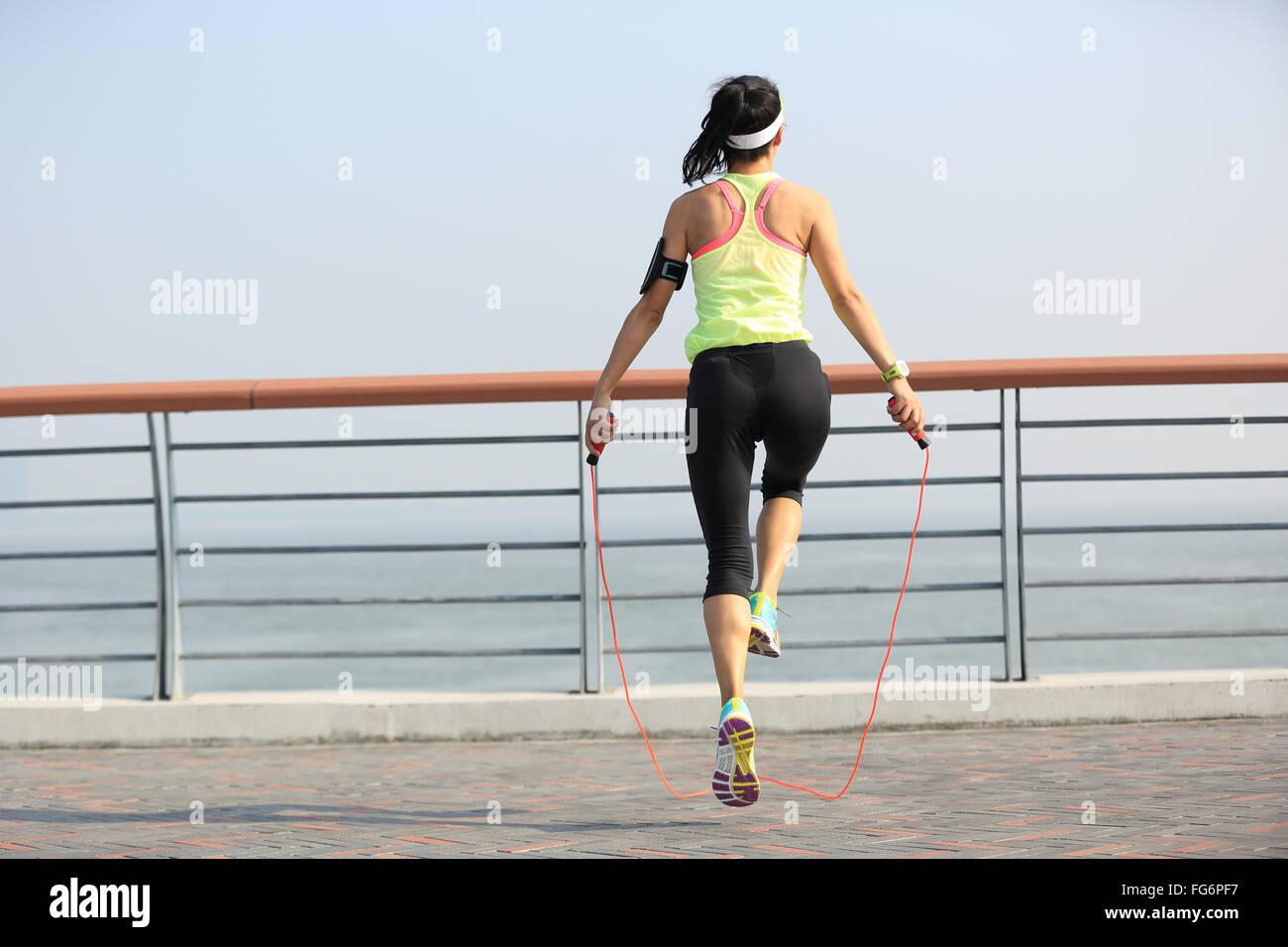 young fitness woman jumping rope at seaside Stock Photo - Alamy