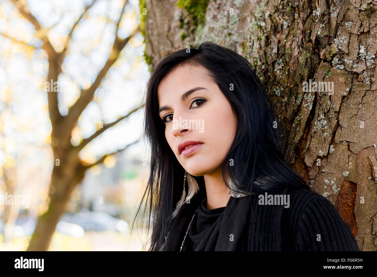 A young aboriginal female model headshot in the outdoors in autumn with ...