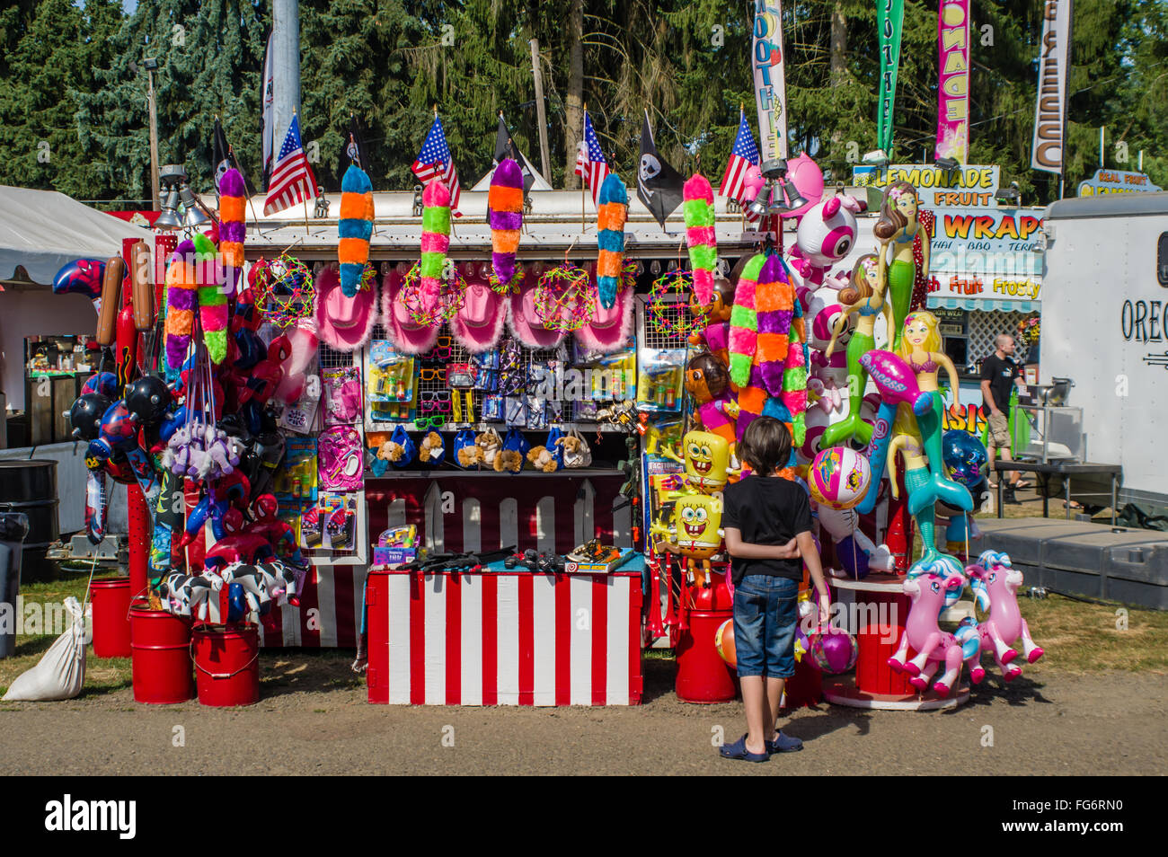 Small boy looking at toys at a vendor booth at the lackamas County Fair ...