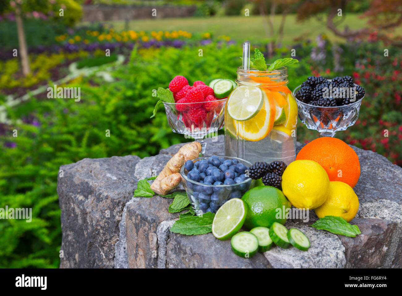 A fresh assortment of fruits, berries and produce set up in a garden ...