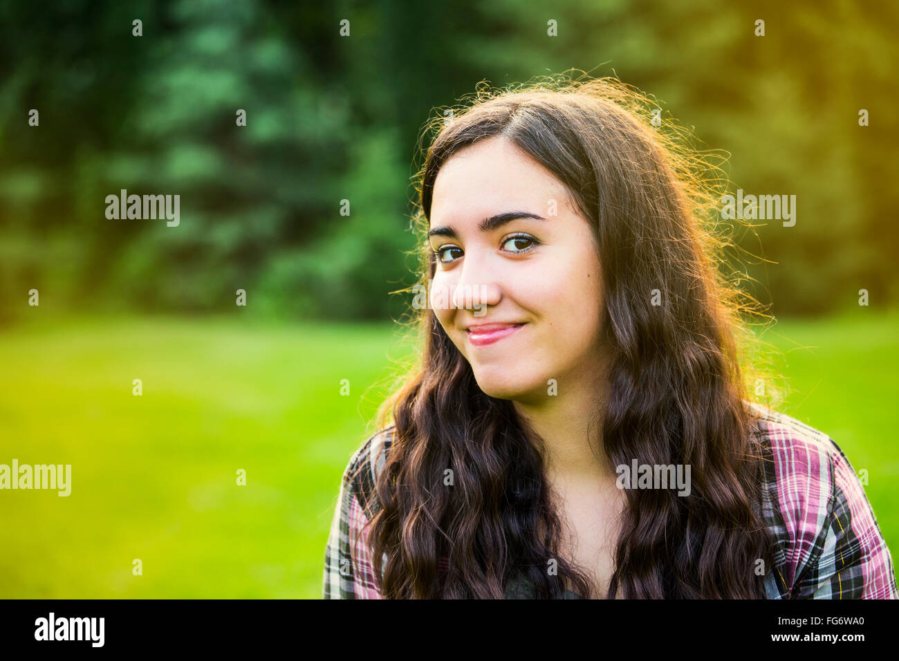 Portrait of a young woman outdoors at sunset; Sherwood Park, Alberta ...