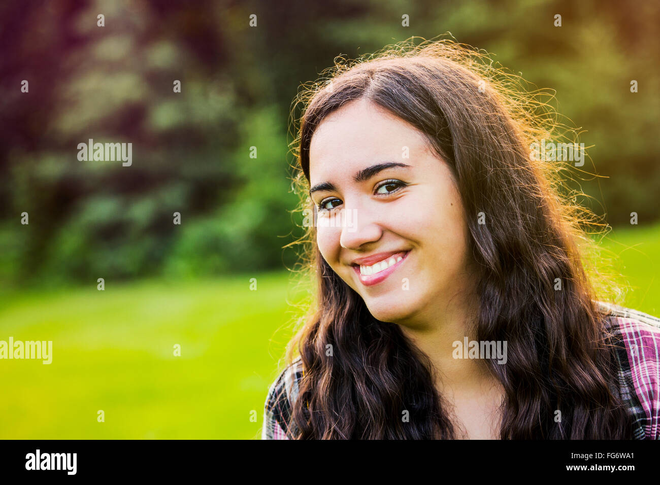 Portrait of a young woman outdoors at sunset; Sherwood Park, Alberta ...