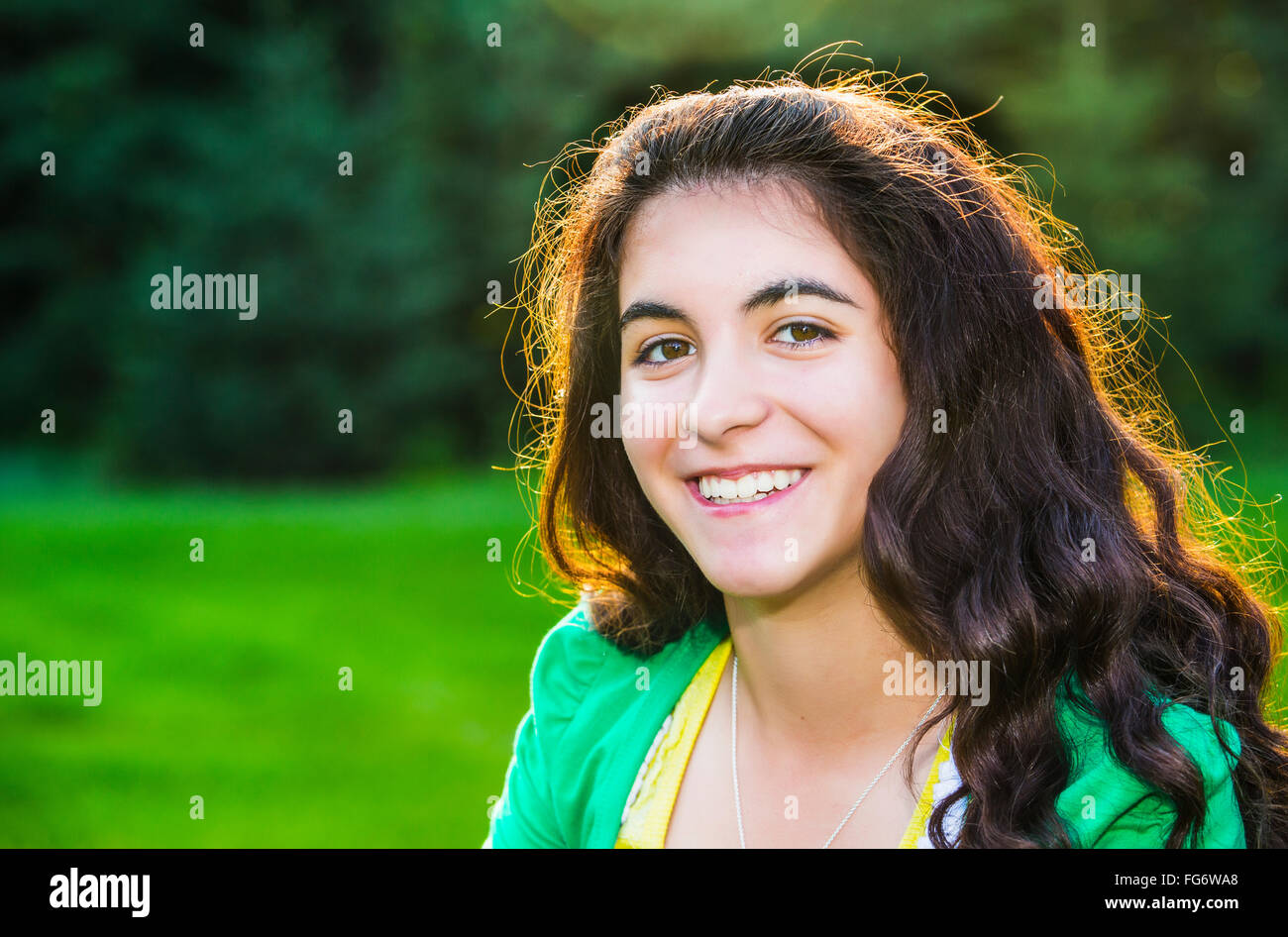 Portrait of a young woman outdoors at sunset; Sherwood Park, Alberta ...