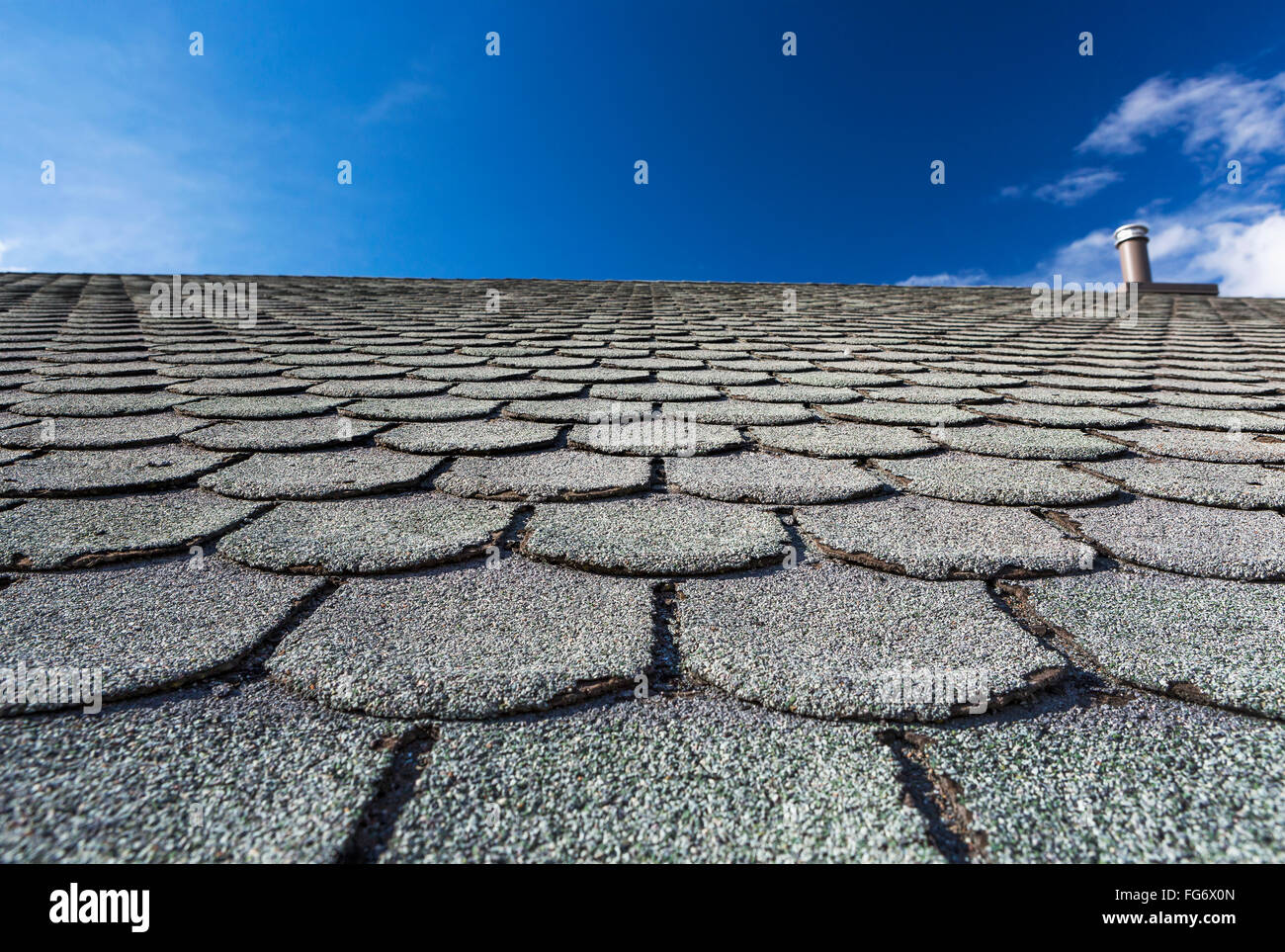 Close up of well worn rounded roof shingles with intersting contours ...