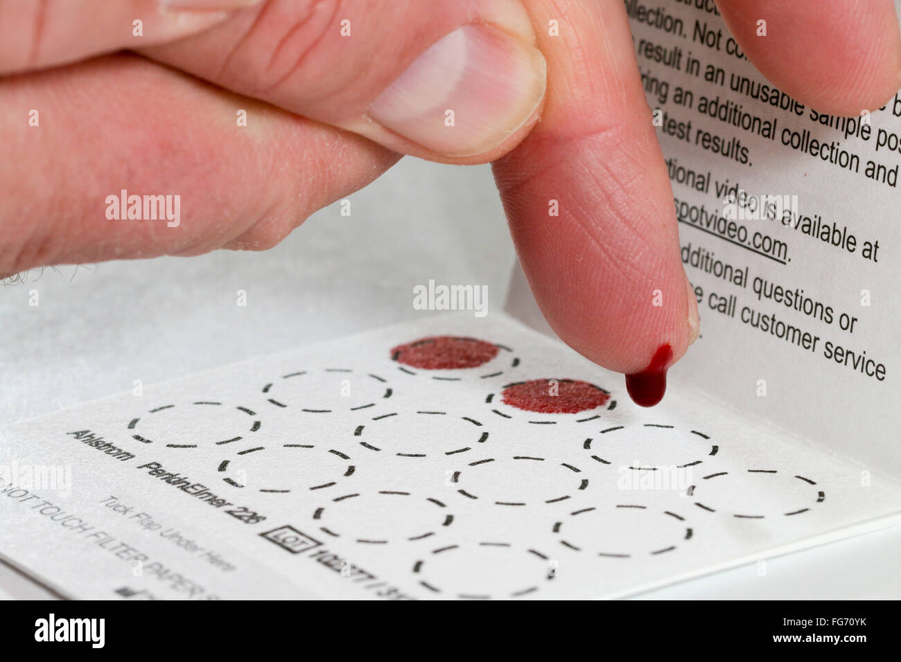 Home blood test. Depositing blood on filter paper Stock Photo - Alamy