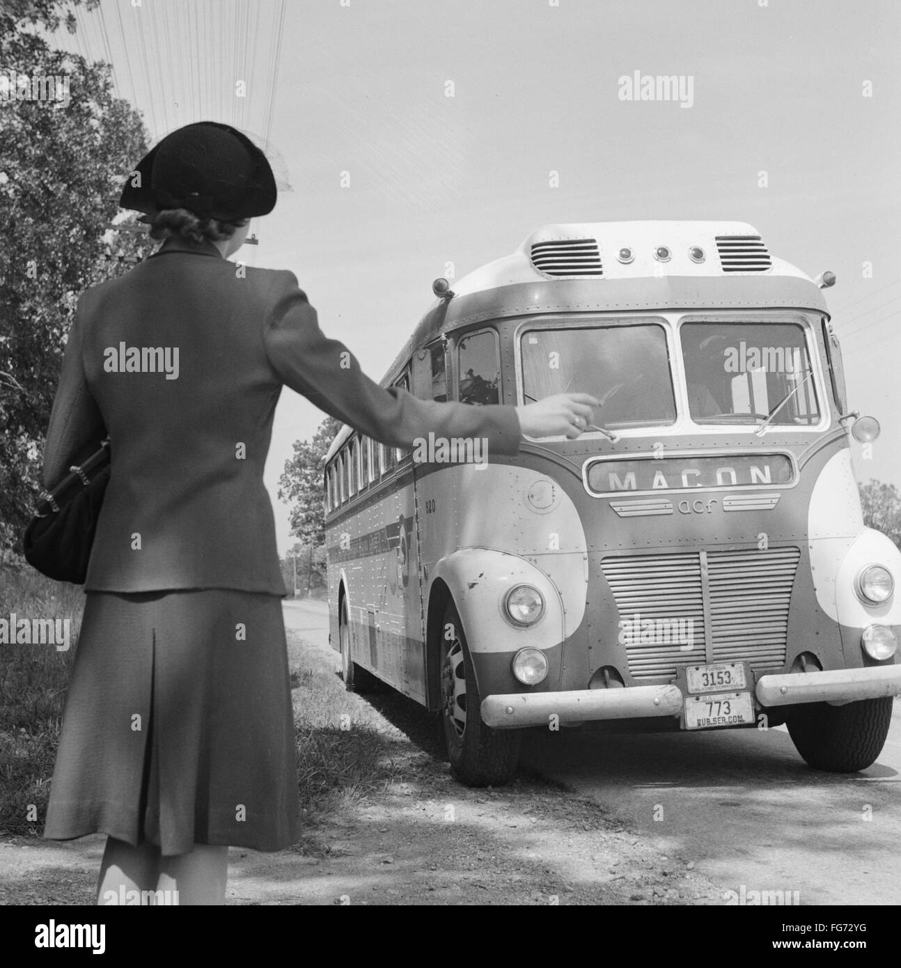 GEORGIA: BUS TRAVEL, 1943. /nA woman hailing a Macon-bound Greyhound ...