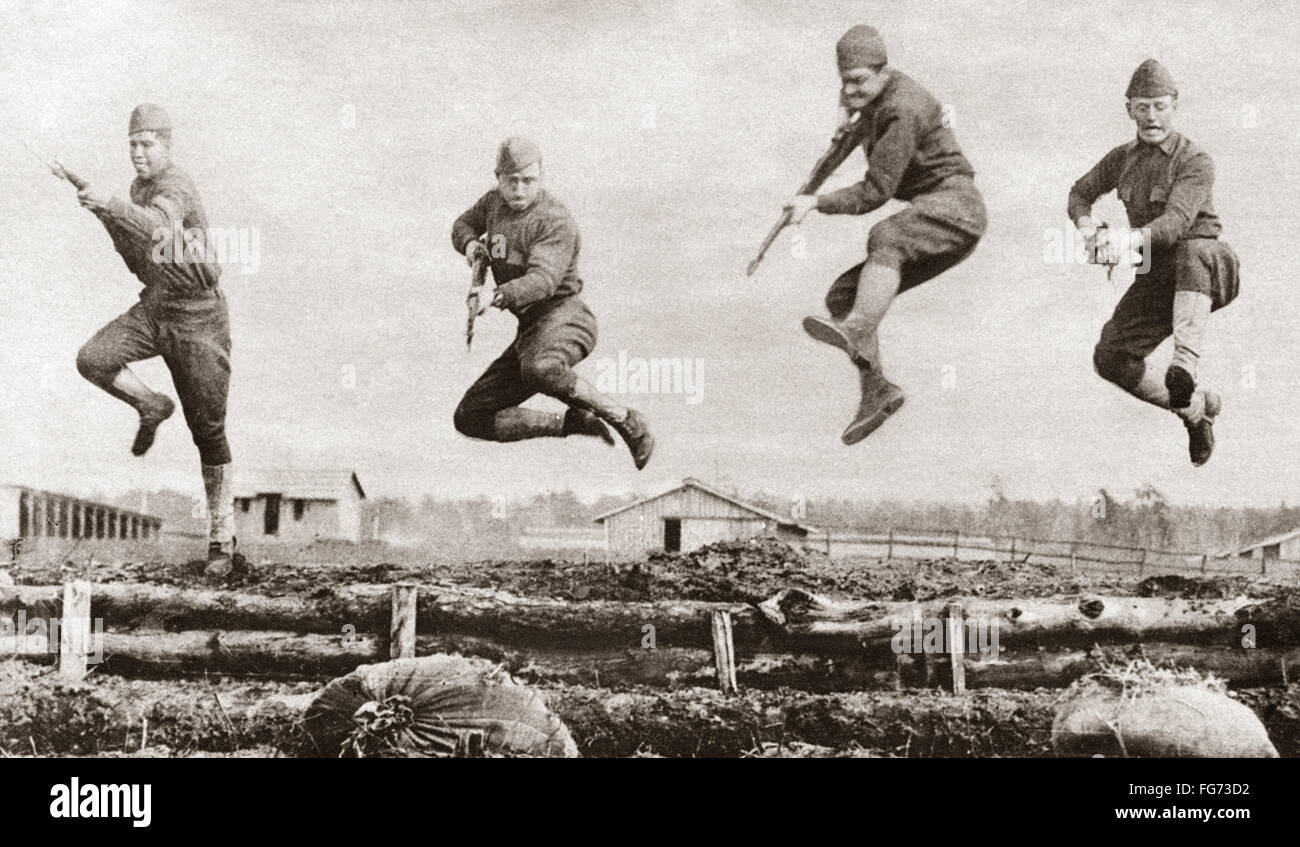 WORLD WAR I: CAMP UPTON. /nAmerican troops leaping over a trench border ...