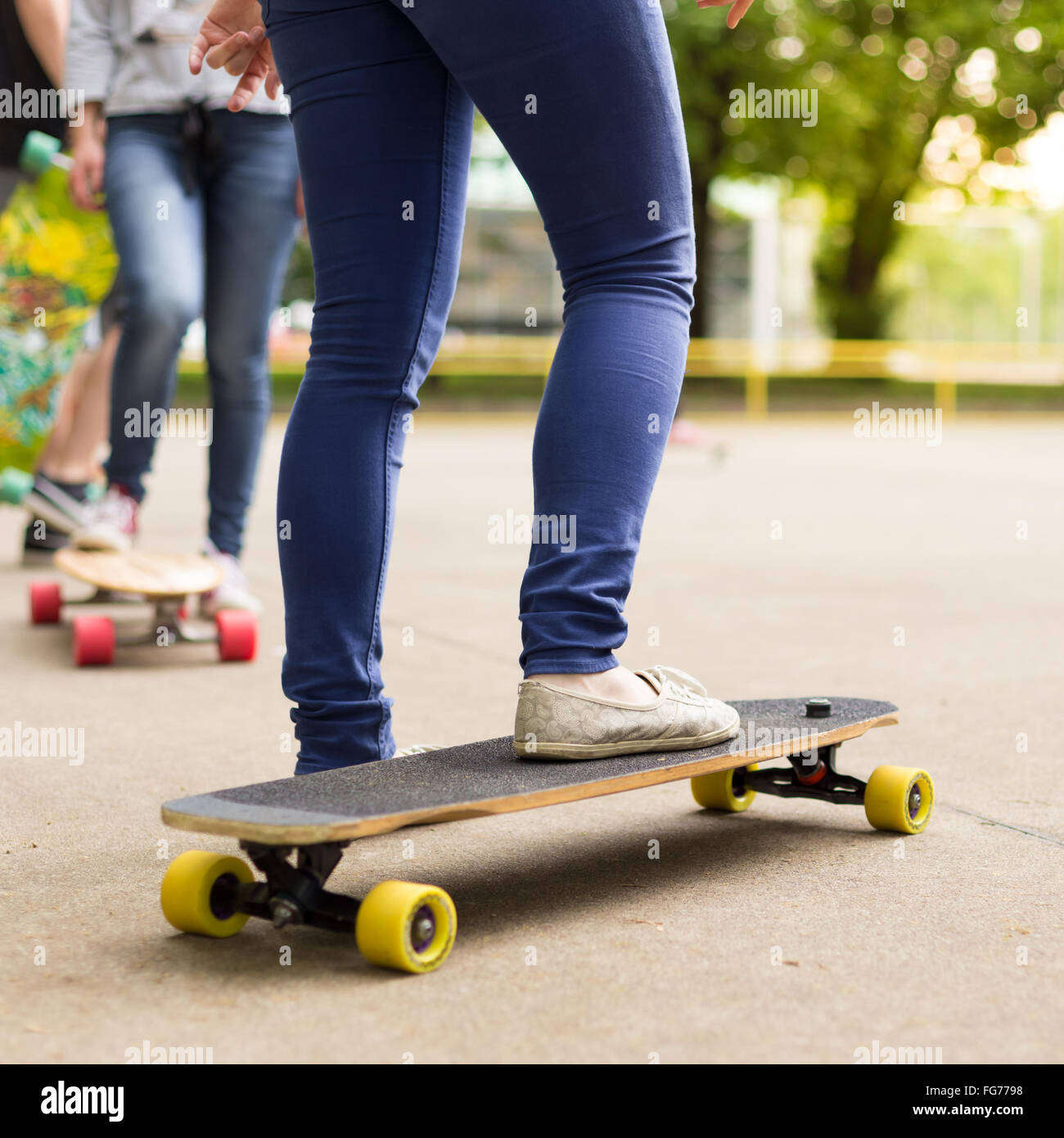 Teenage girl practicing riding long board Stock Photo - Alamy