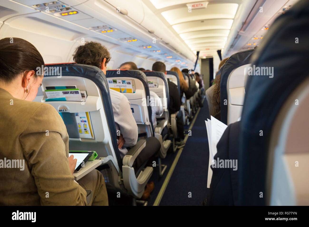 Passengers on the airplane Stock Photo - Alamy