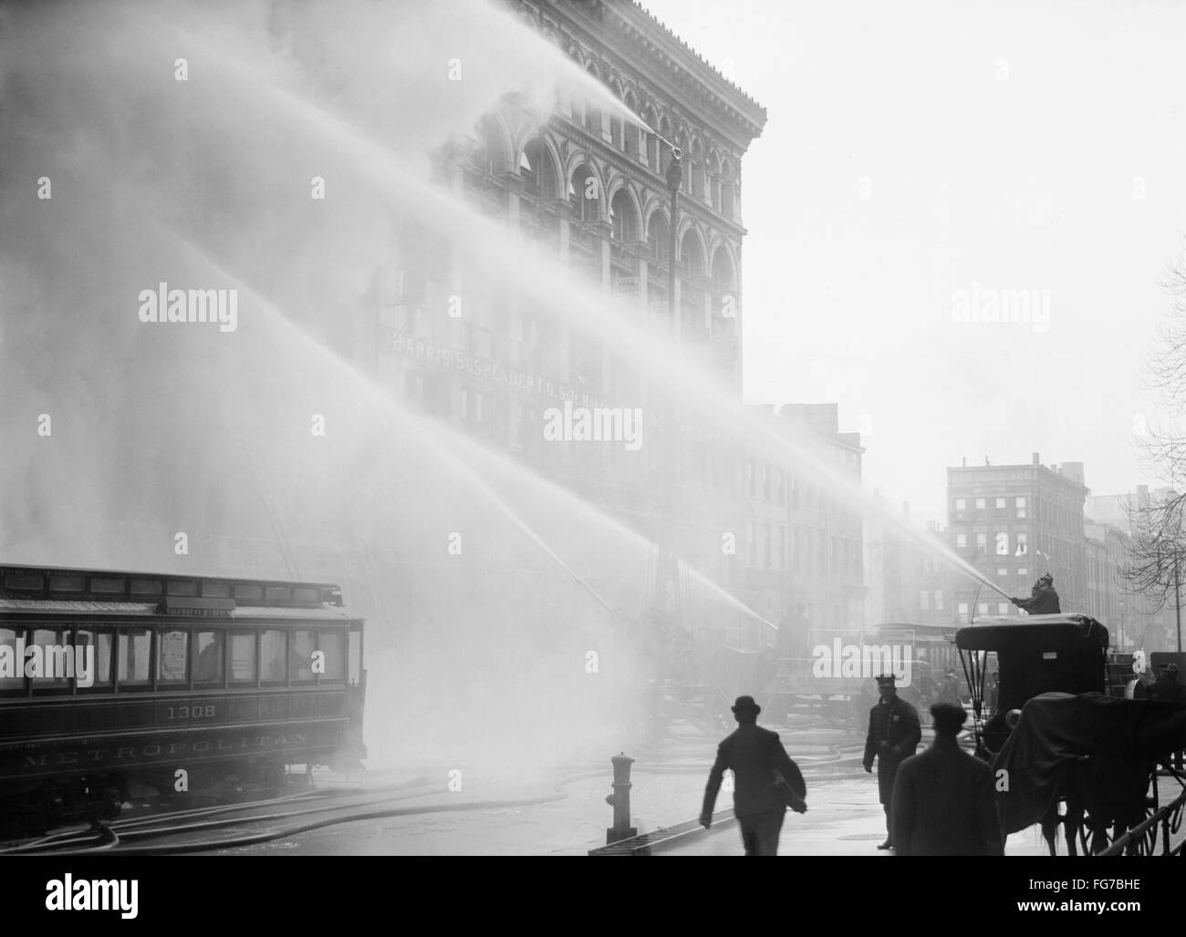 NYC: FIRE, 1909. /nFiremen spraying a burning building on 14th Street ...