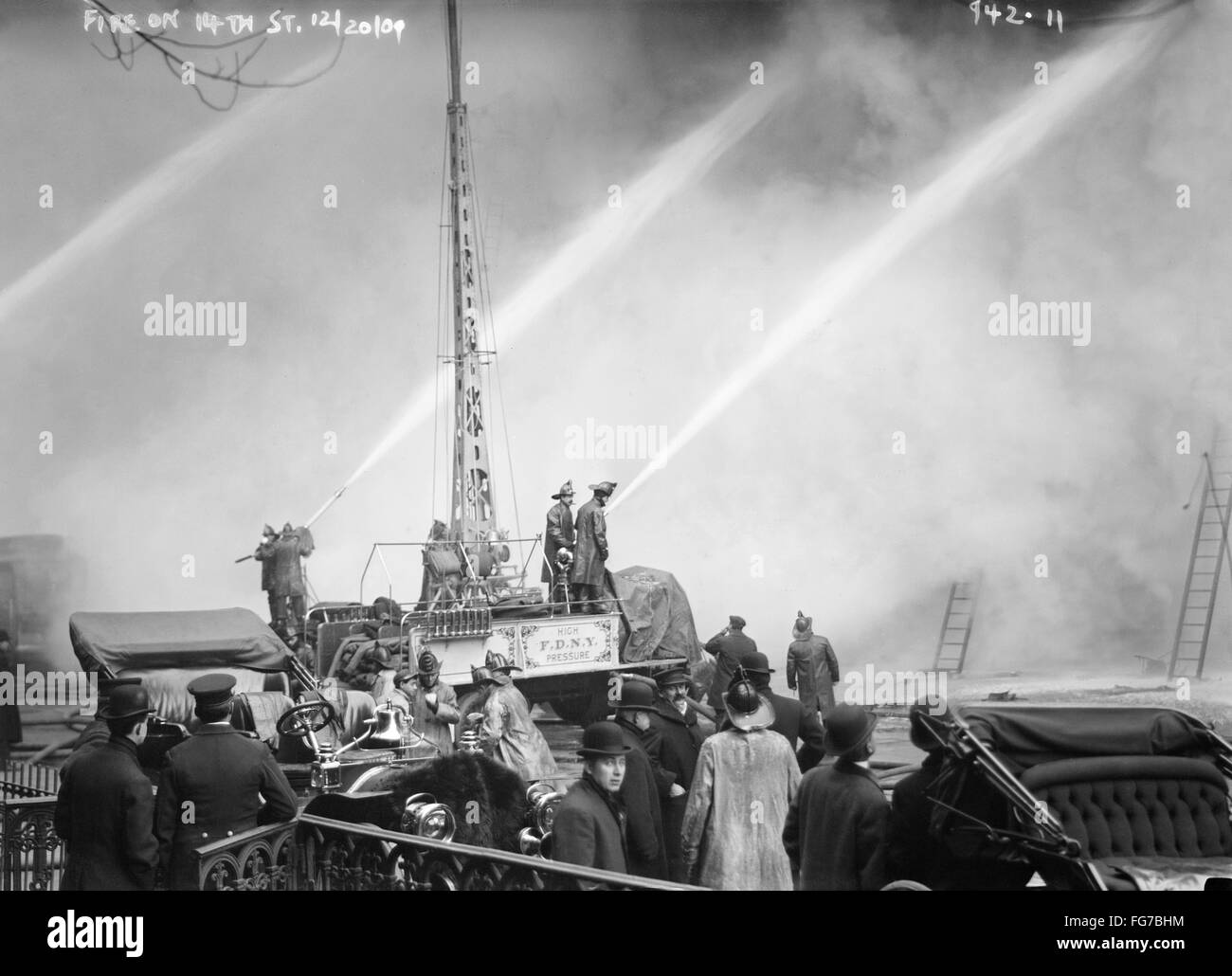 NYC: FIRE, 1909. /nFiremen spraying a burning building on 14th Street ...