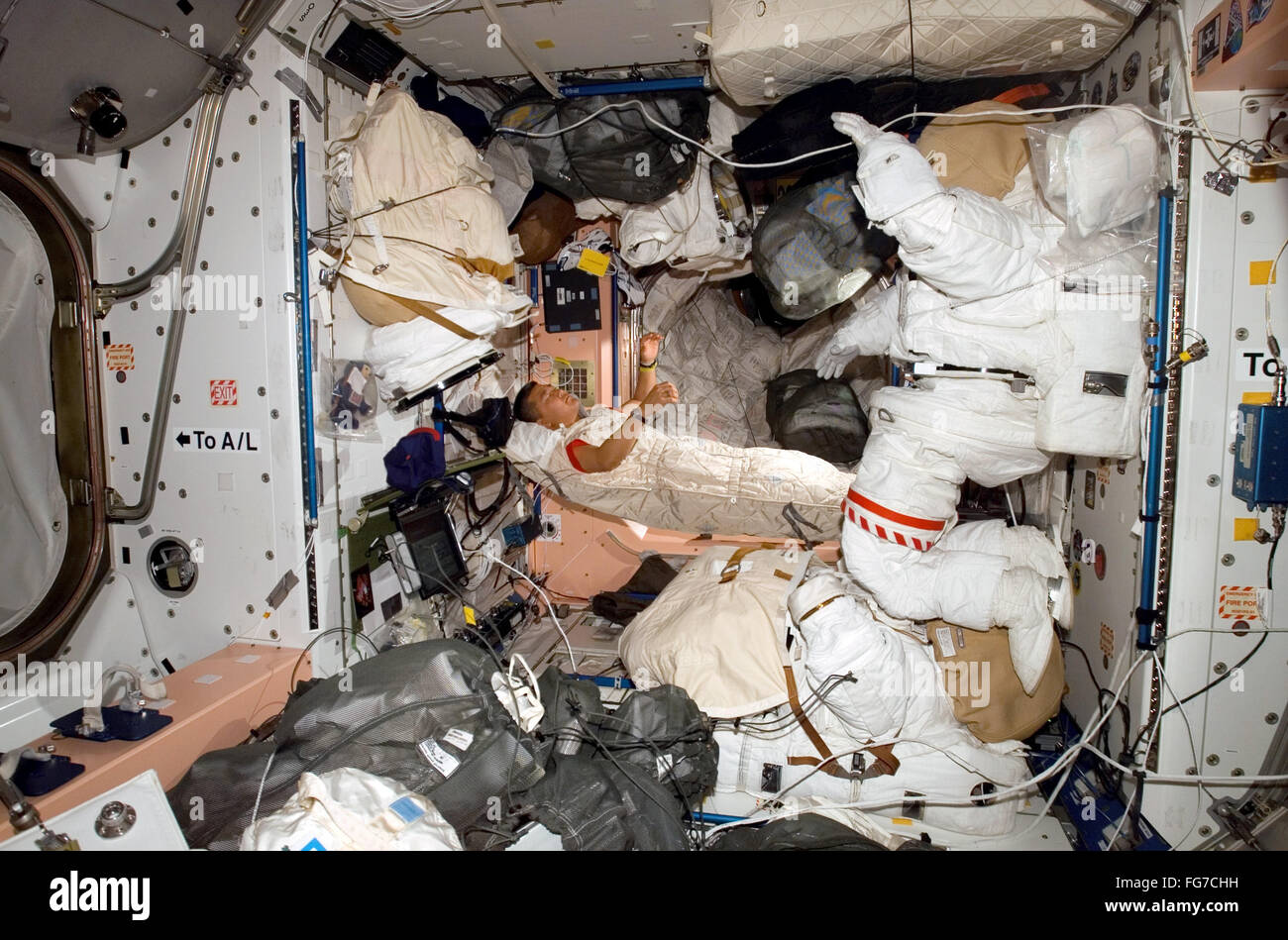 SPACE STATION, 2007. /nAmerican astronaut Daniel Tani sleeping in the ...