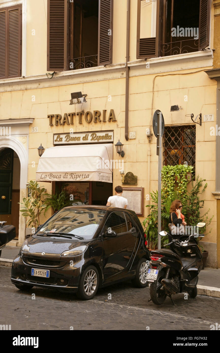 Brabus Smart car and motorscooter parked outside restaurant in ...