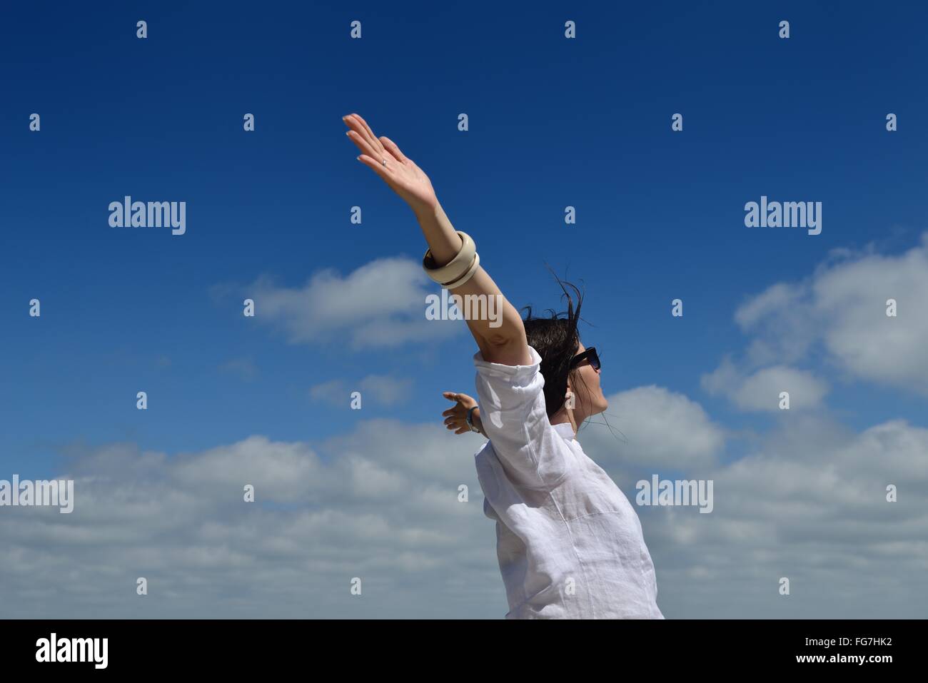 young woman with spreading arms to sky Stock Photo - Alamy