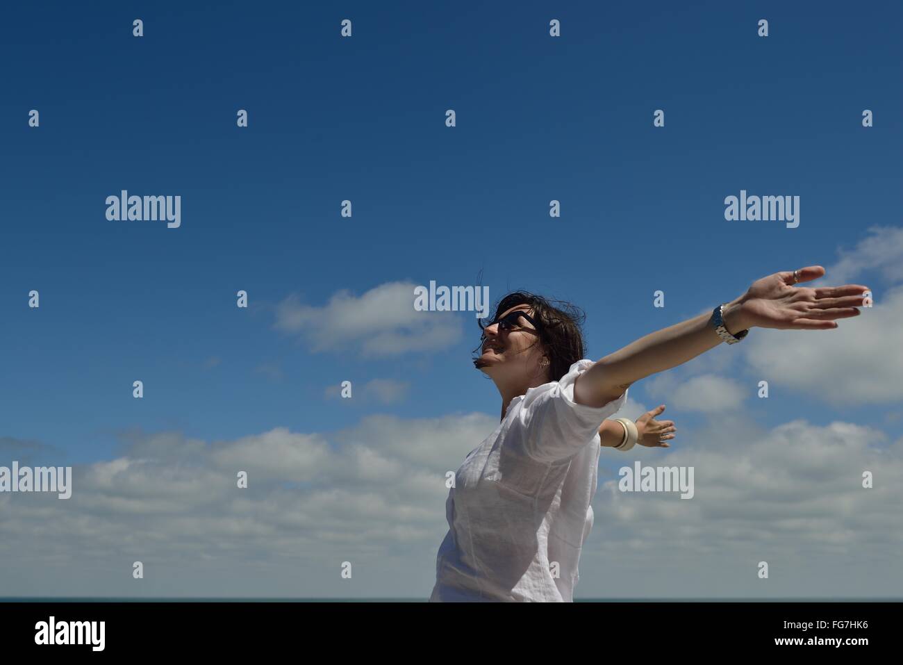 young woman with spreading arms to sky Stock Photo - Alamy