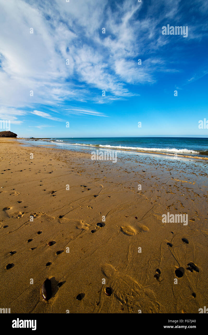 footstep in lanzarote spain rock stone sky cloud beach water musk pond ...