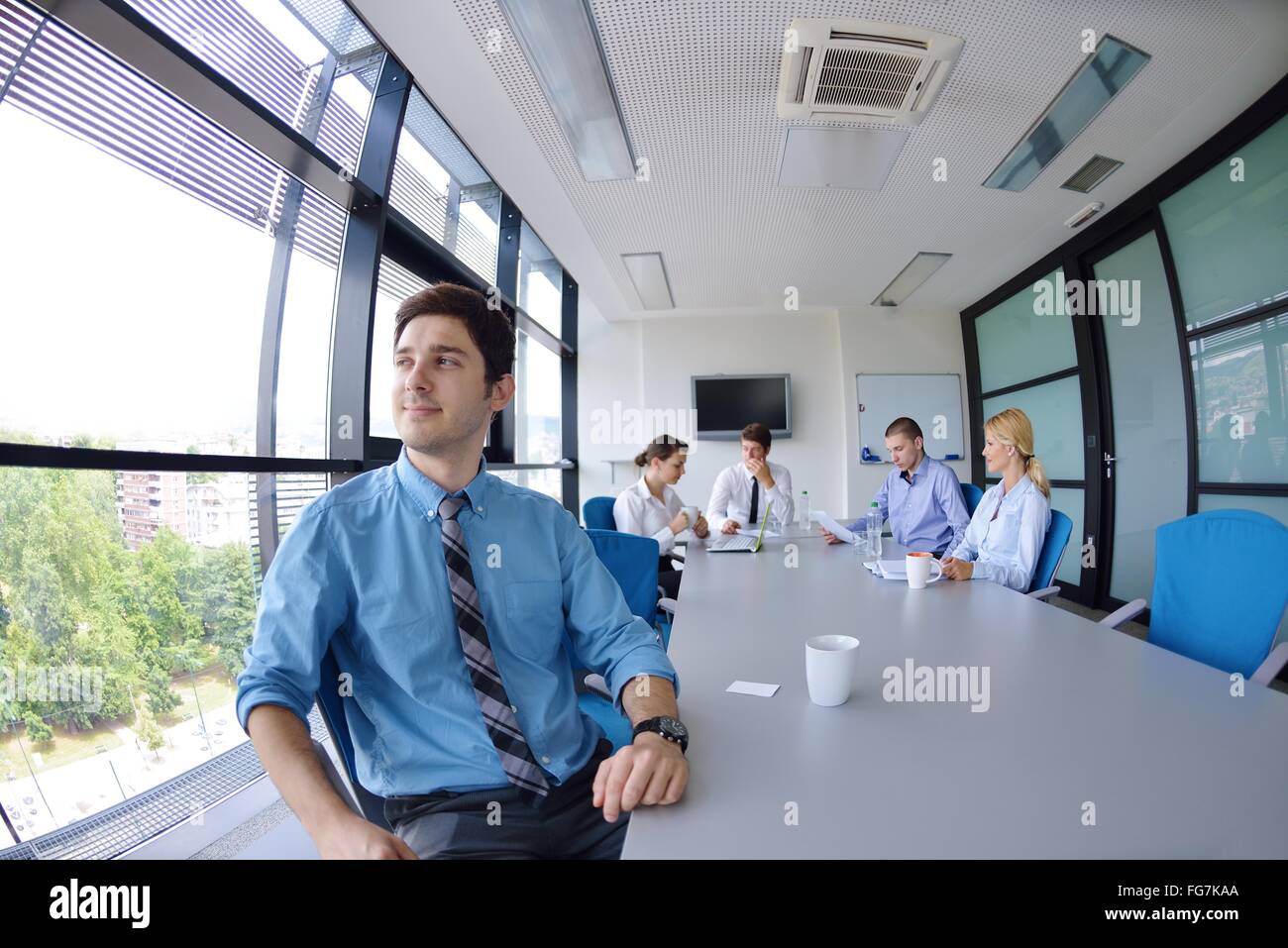 business man on a meeting in offce with colleagues in background Stock ...