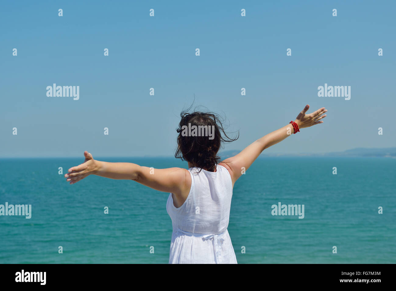 happy young woman with spreading arms to sky Stock Photo - Alamy