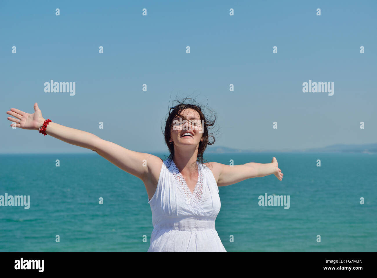 happy young woman with spreading arms to sky Stock Photo - Alamy