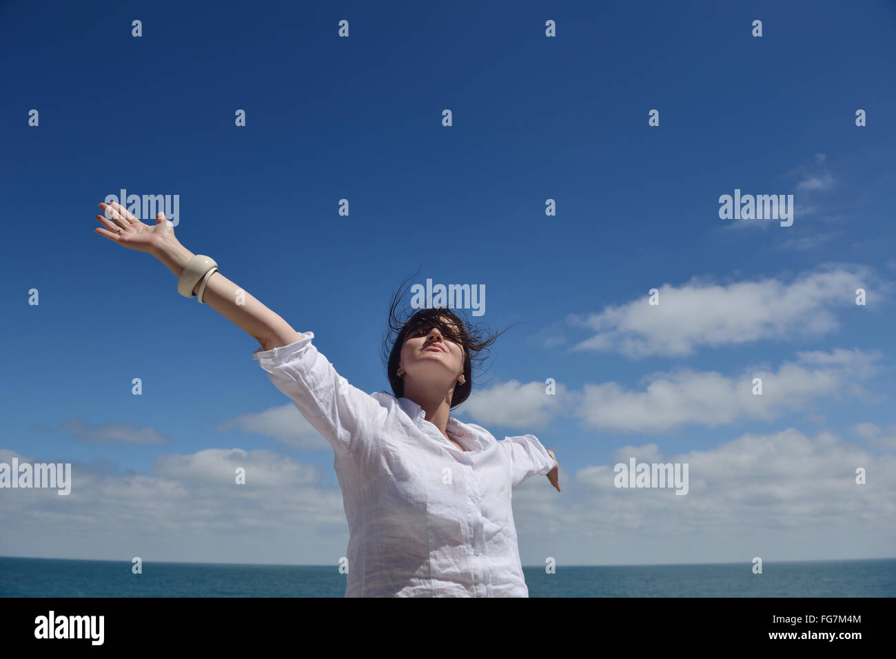 happy young woman with spreading arms to sky Stock Photo - Alamy