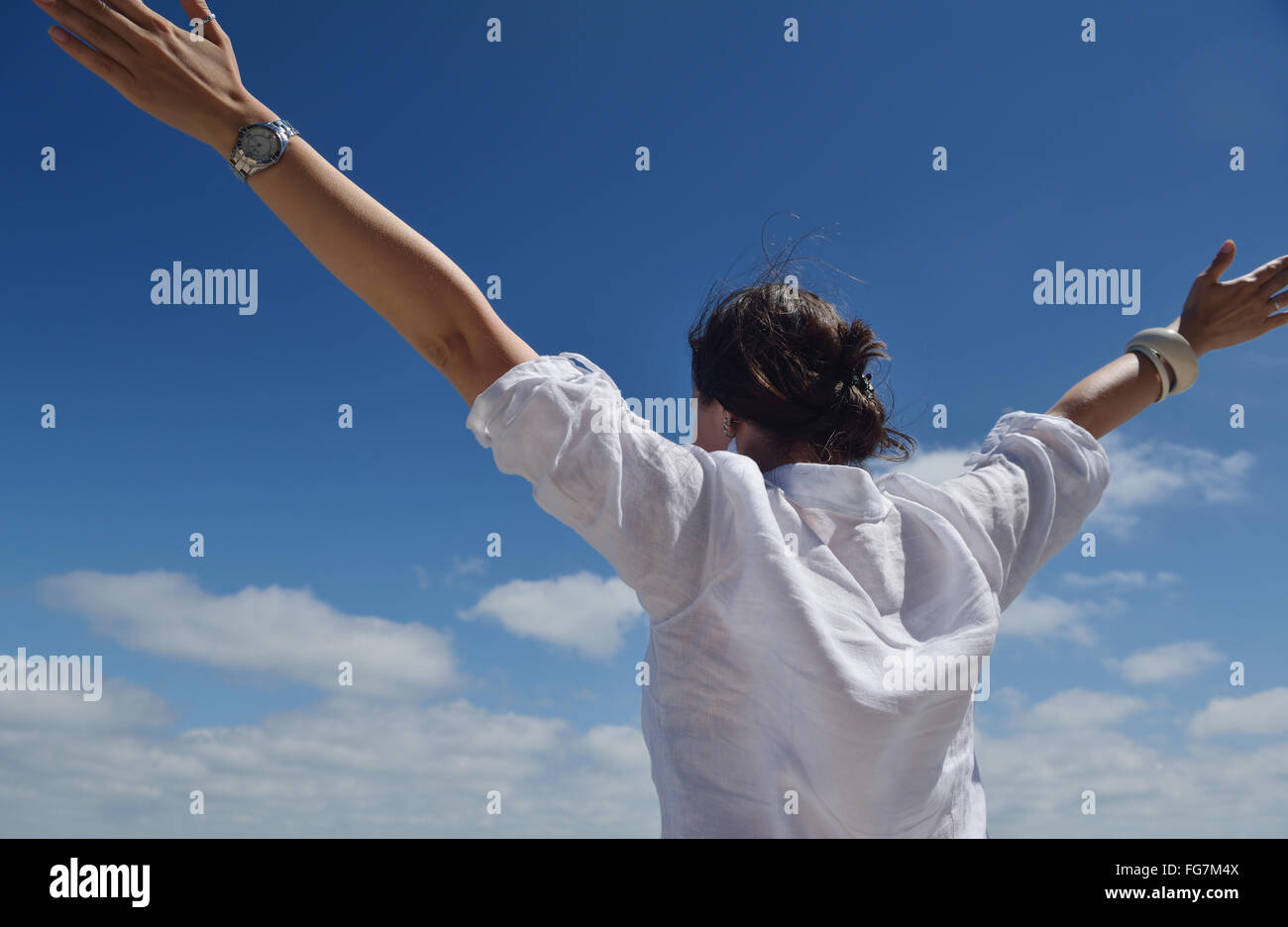 happy young woman with spreading arms to sky Stock Photo - Alamy