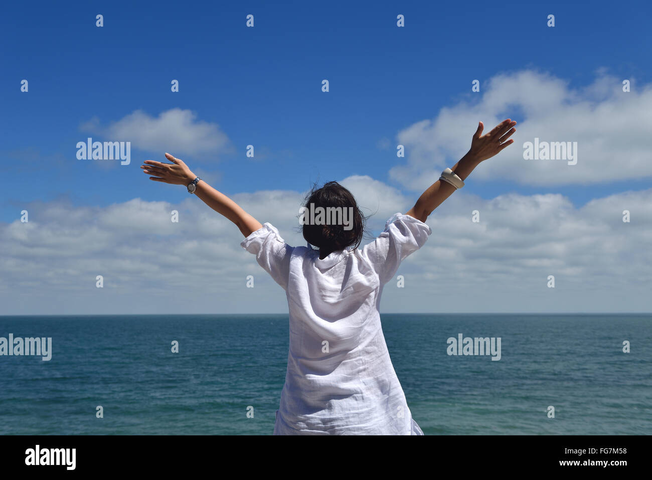 happy young woman with spreading arms to sky Stock Photo - Alamy