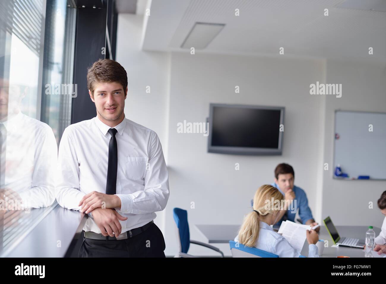 business man on a meeting in offce with colleagues in background Stock ...