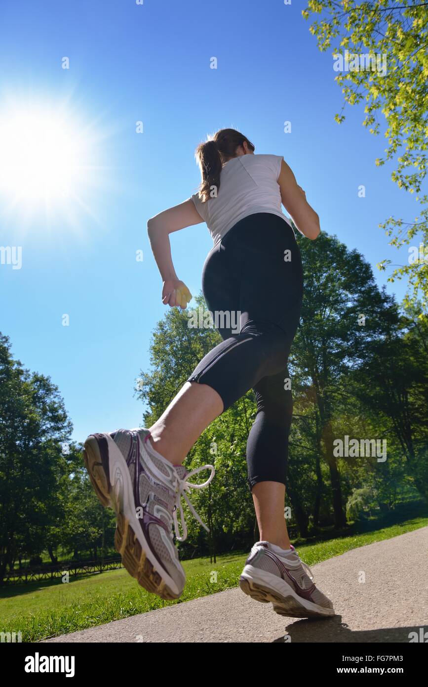Young beautiful woman jogging at morning in park Stock Photo - Alamy