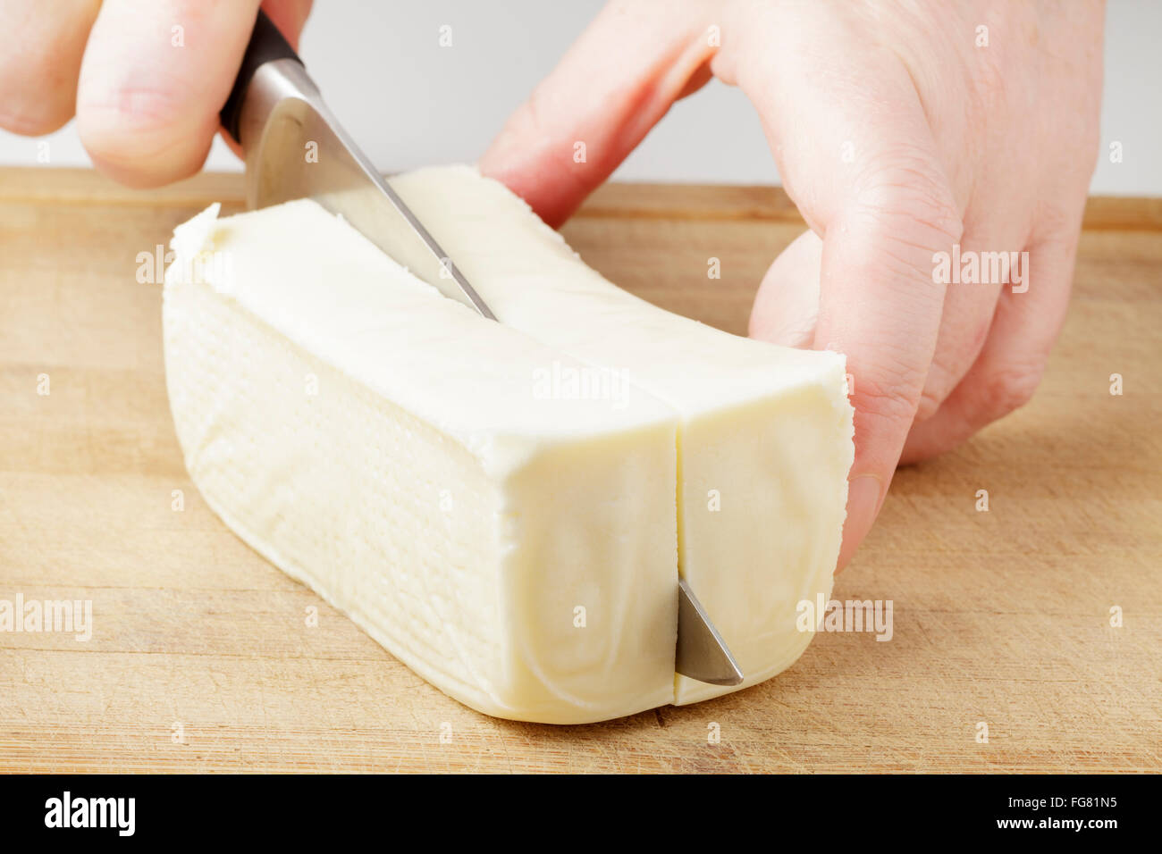 Paneer being cut by chef Stock Photo - Alamy