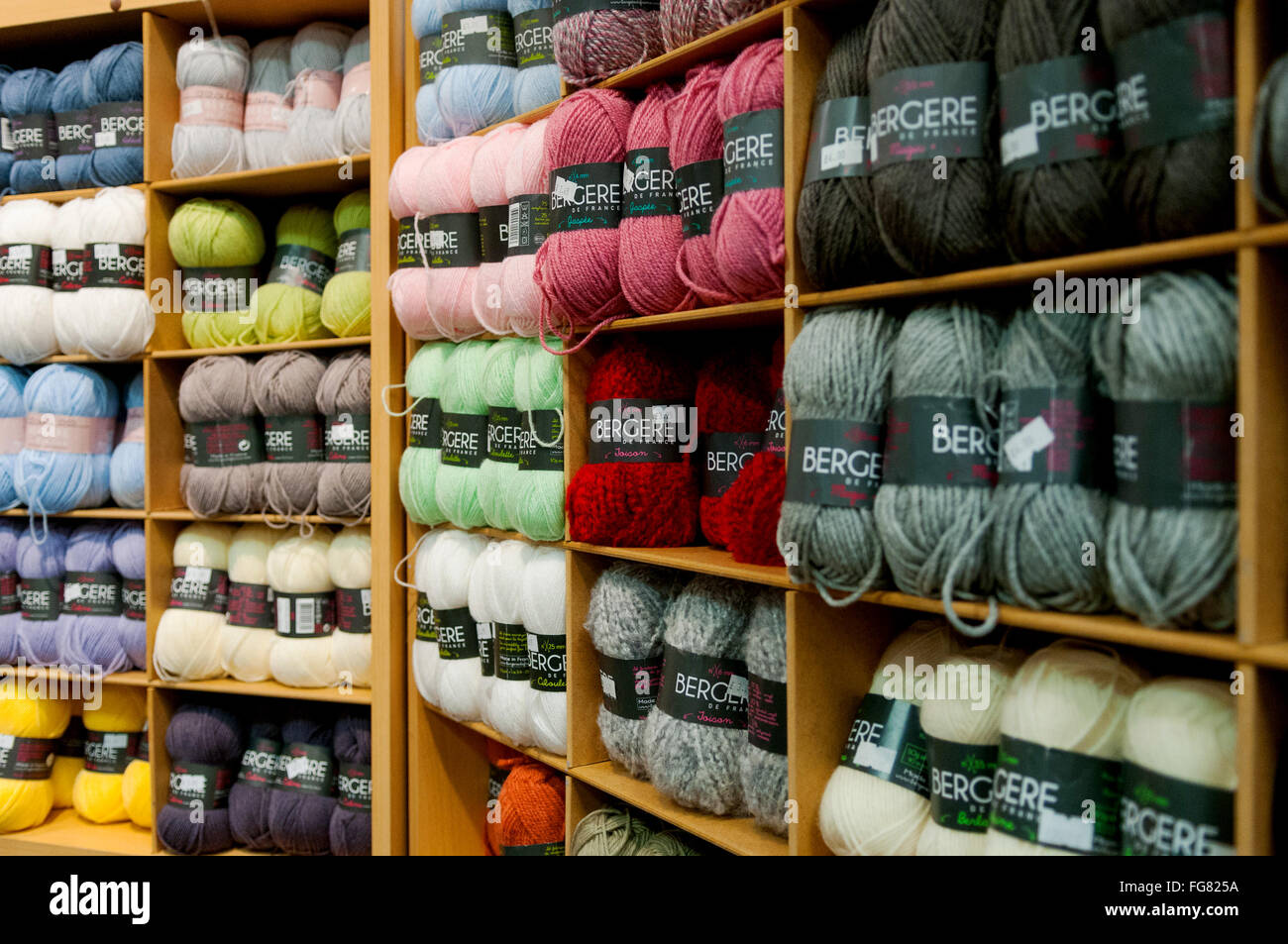 Balls of coloured wool on shelves in a fabric shop Stock Photo - Alamy