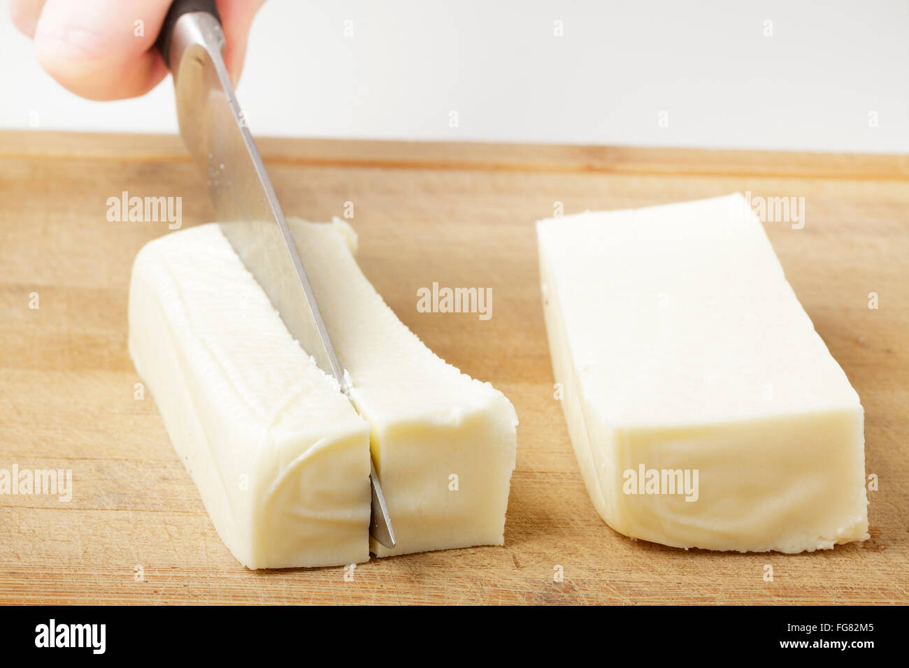 Paneer being cut by chef Stock Photo - Alamy