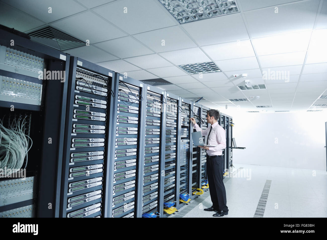 businessman with laptop in network server room Stock Photo - Alamy