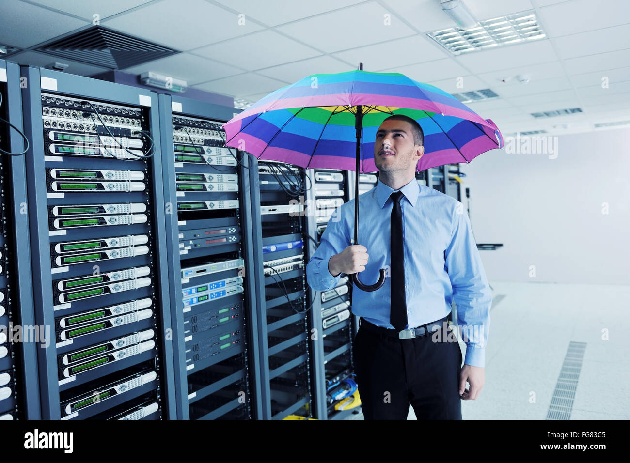 businessman hold umbrella in server room Stock Photo - Alamy