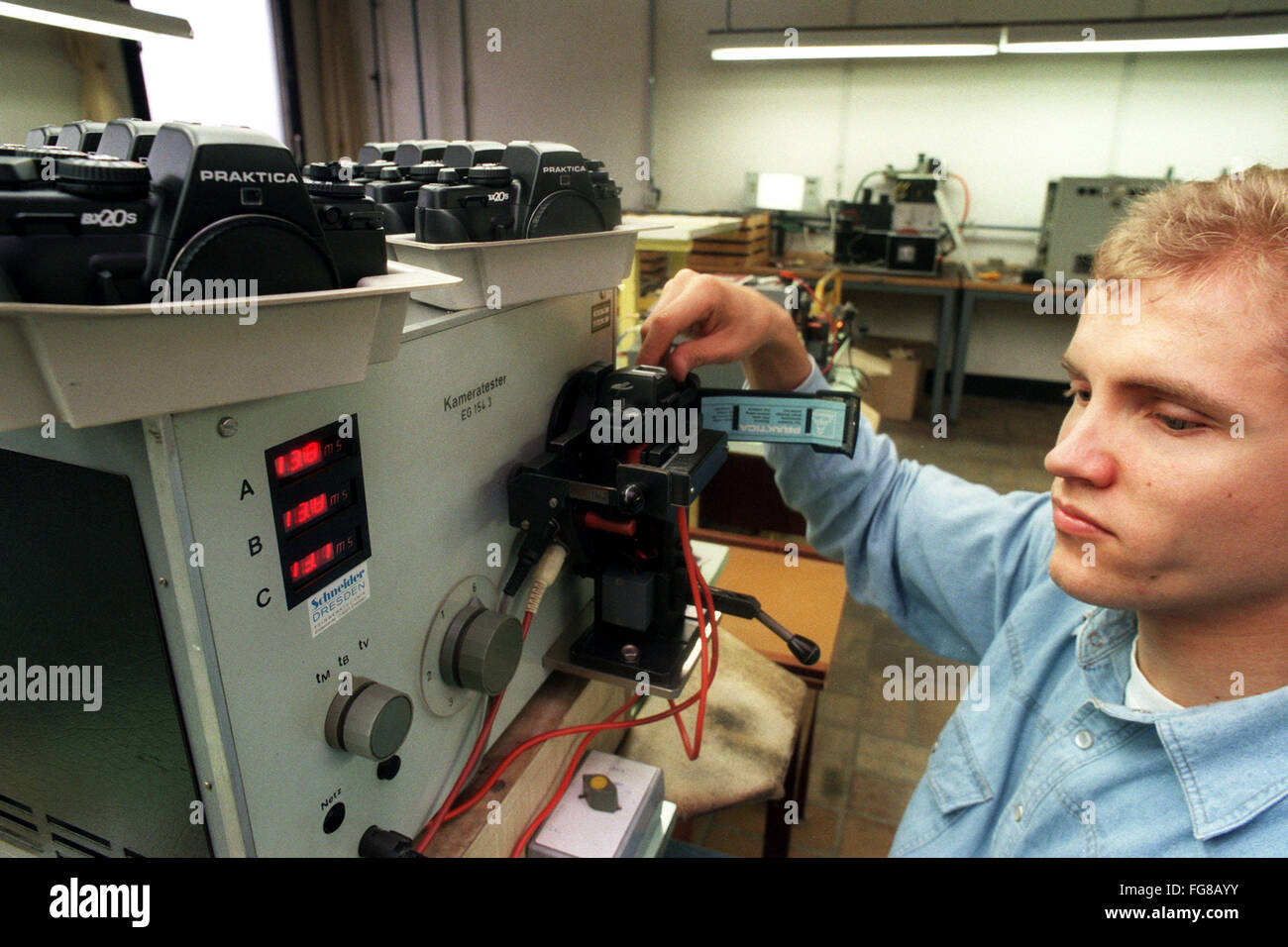 An employee sets the aperture priority at the adjustment device of a ...