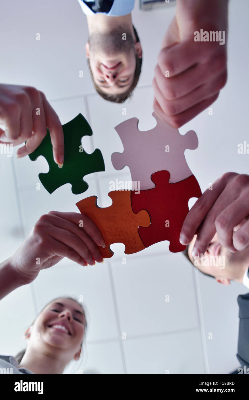 Group of business people assembling jigsaw puzzle Stock Photo - Alamy