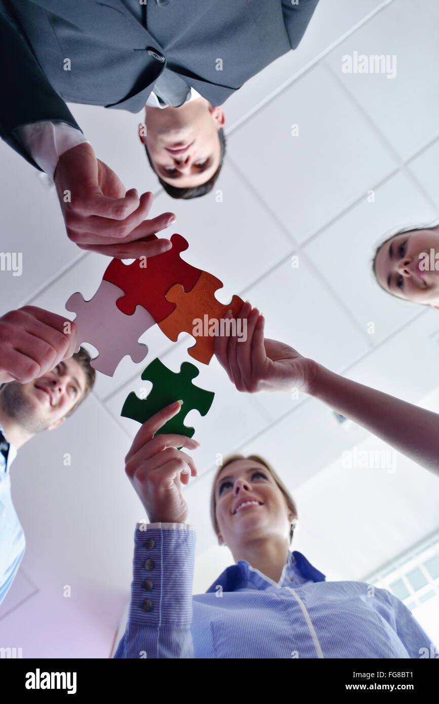 Group of business people assembling jigsaw puzzle Stock Photo - Alamy
