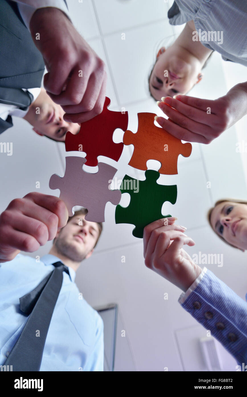 Group of business people assembling jigsaw puzzle Stock Photo - Alamy