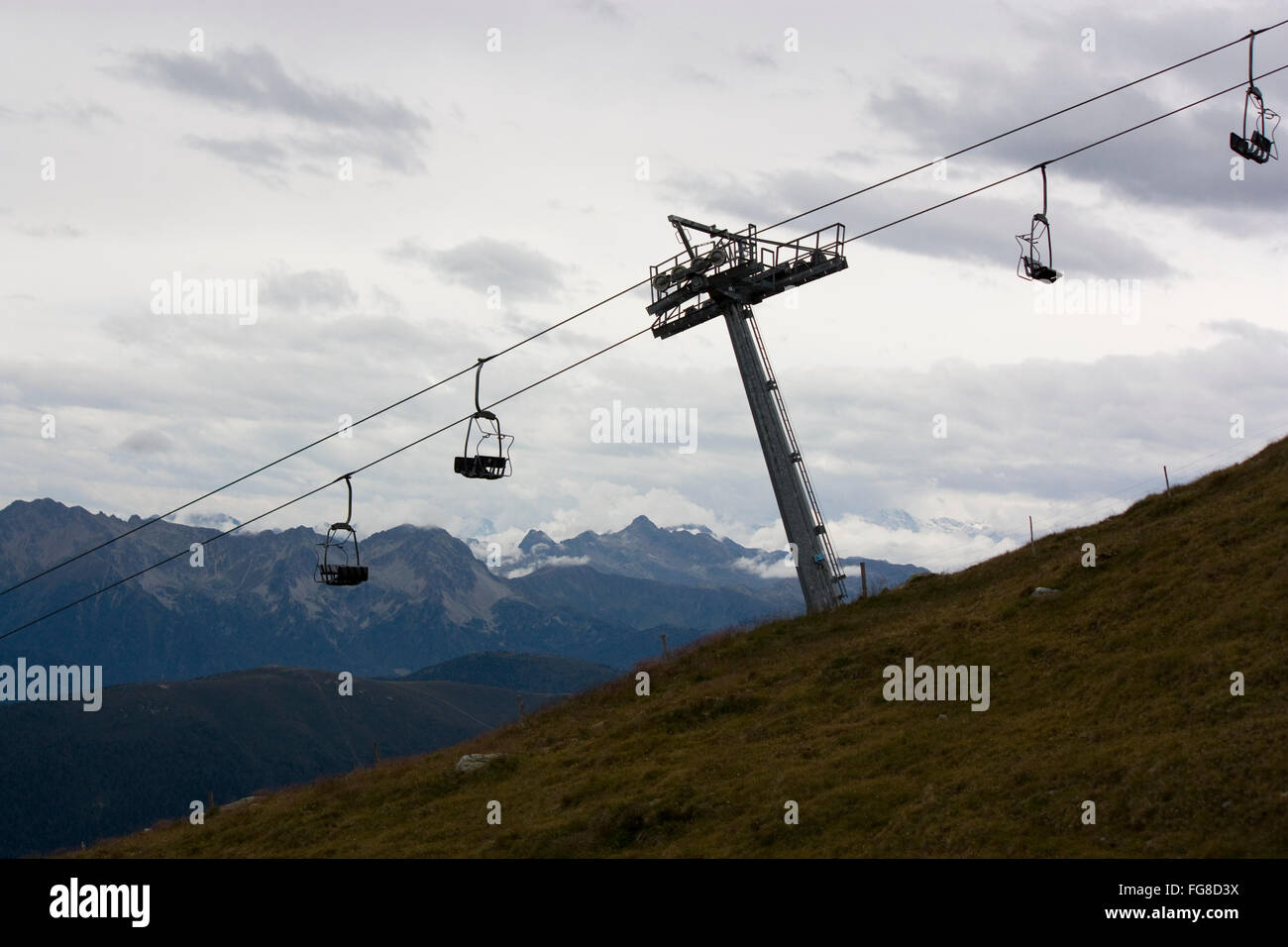 Overhead Cable Car At Field Against Mountains Stock Photo - Alamy