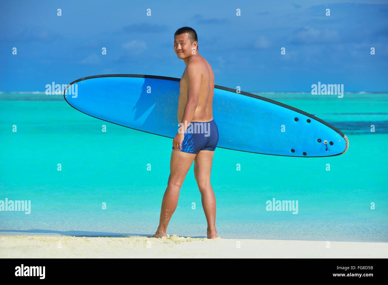 Man with surf board on beach Stock Photo - Alamy