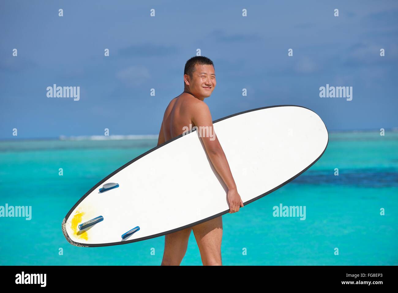 Man with surf board on beach Stock Photo - Alamy
